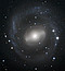 Barred spiral galaxy swirls in the night sky | ESO
